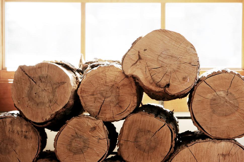 Free Stock Photo of Stacked tree logs indoors near bright window in ...
