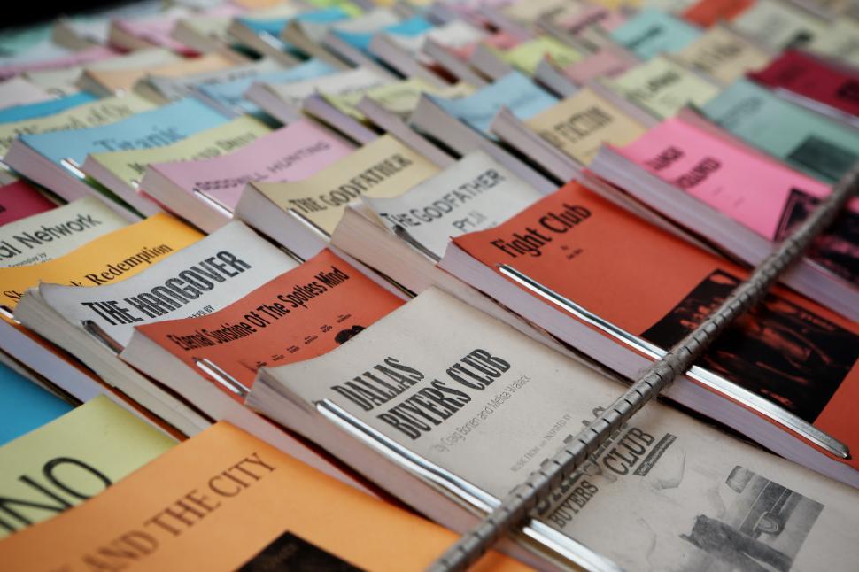 Free Stock Photo of Assorted colorful screenplays neatly arranged in ...