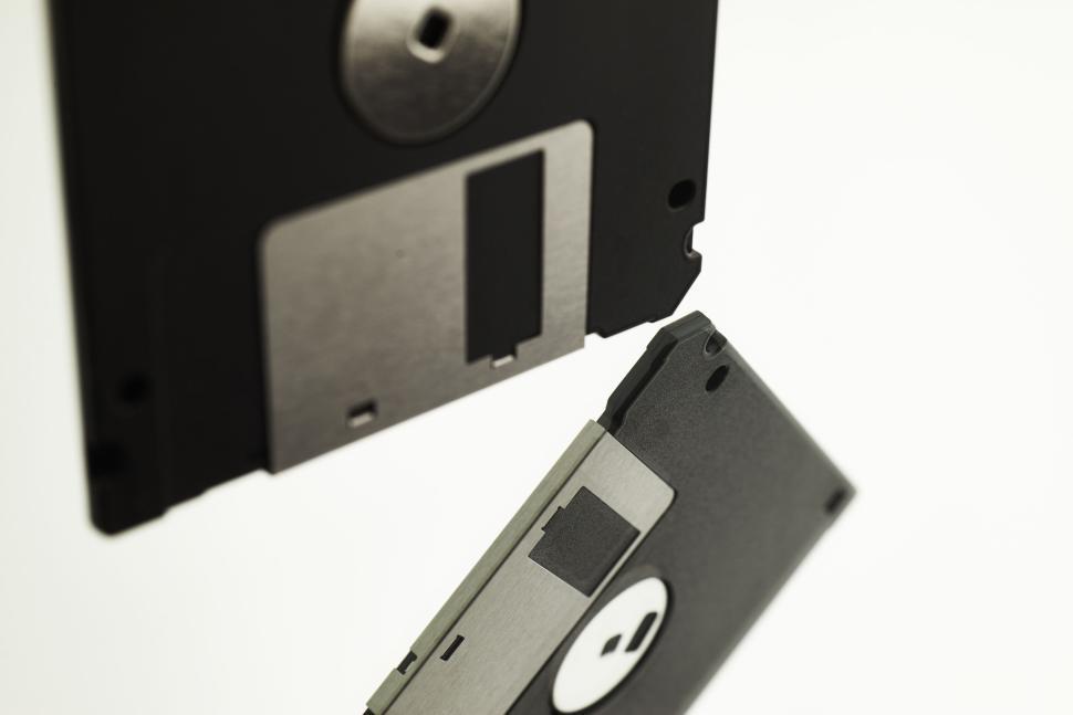 Free Stock Photo of Pair of black floppy disks featuring silver and ...