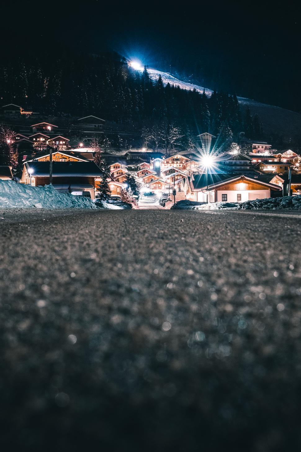 Free Stock Photo of Snowy hillside village at night with warmly lit ...