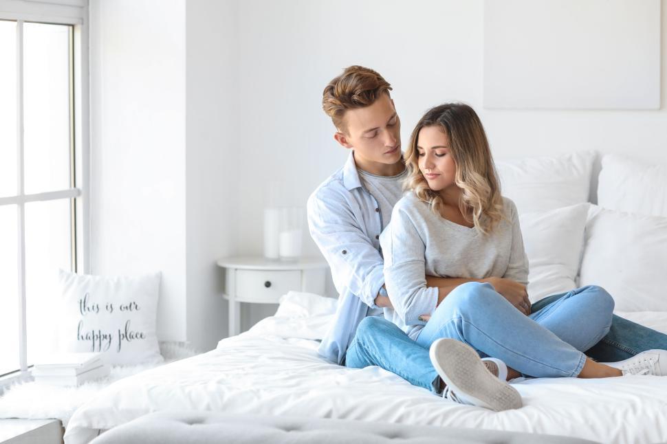 Free Stock Photo of Couple sharing an intimate moment on a bed in a ...