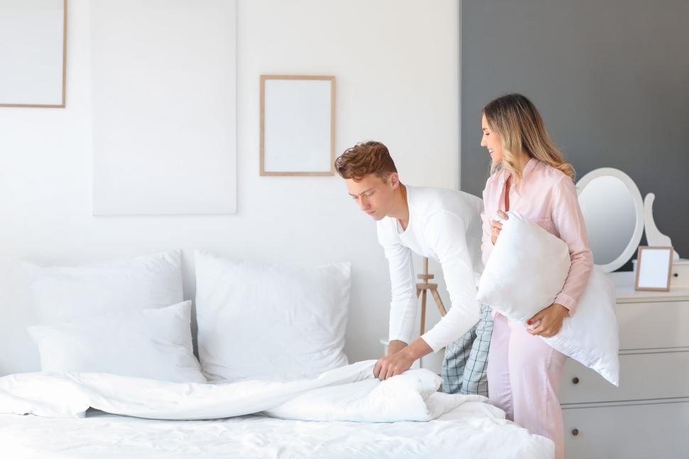 Free Stock Photo of Couple making the bed together in a bright and ...