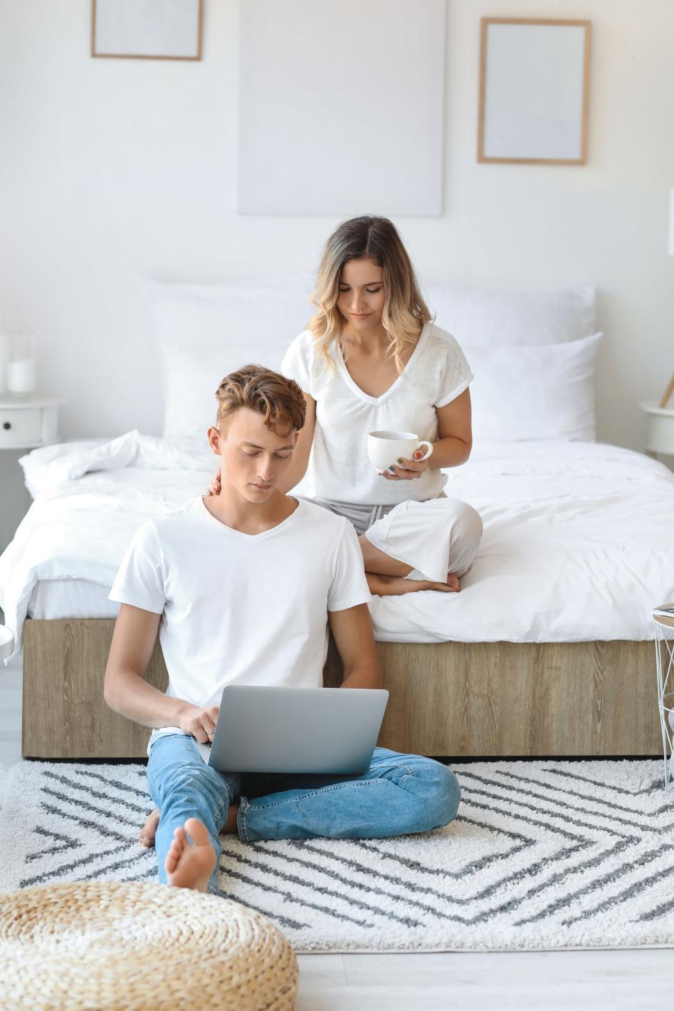 Free Stock Photo of Couple in white shirts, laptop on floor, morning ...
