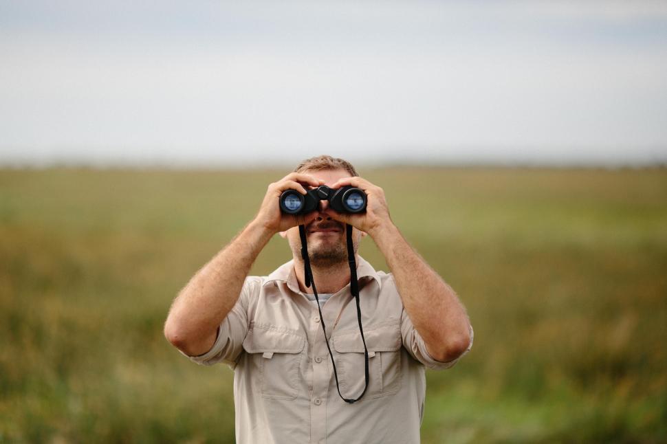 Free Stock Photo of Man bird watching using binoculars in an open ...