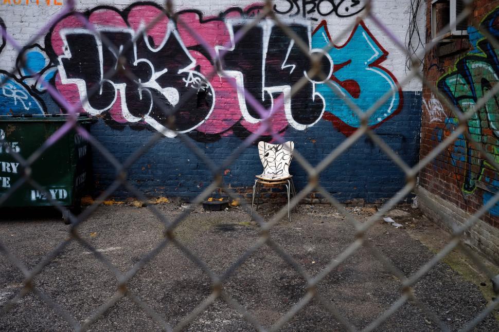 Free Stock Photo of Graffiti-adorned urban alley with lone chair seen ...