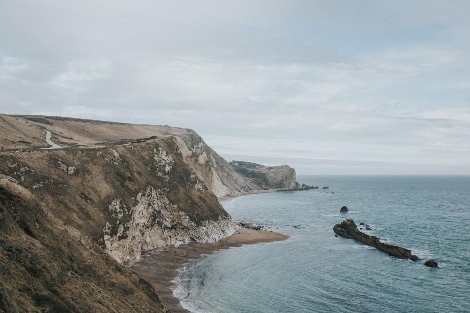 Free Stock Photo of Coastal cliffside overlooking ocean with winding ...