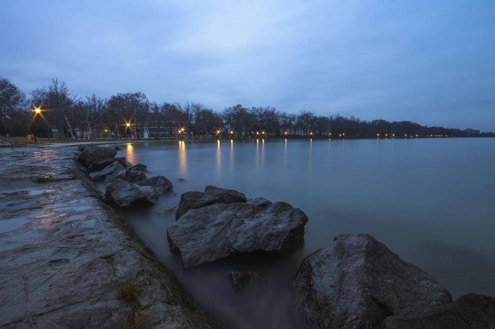 Free Stock Photo of Quiet riverside promenade at dusk with soft street ...