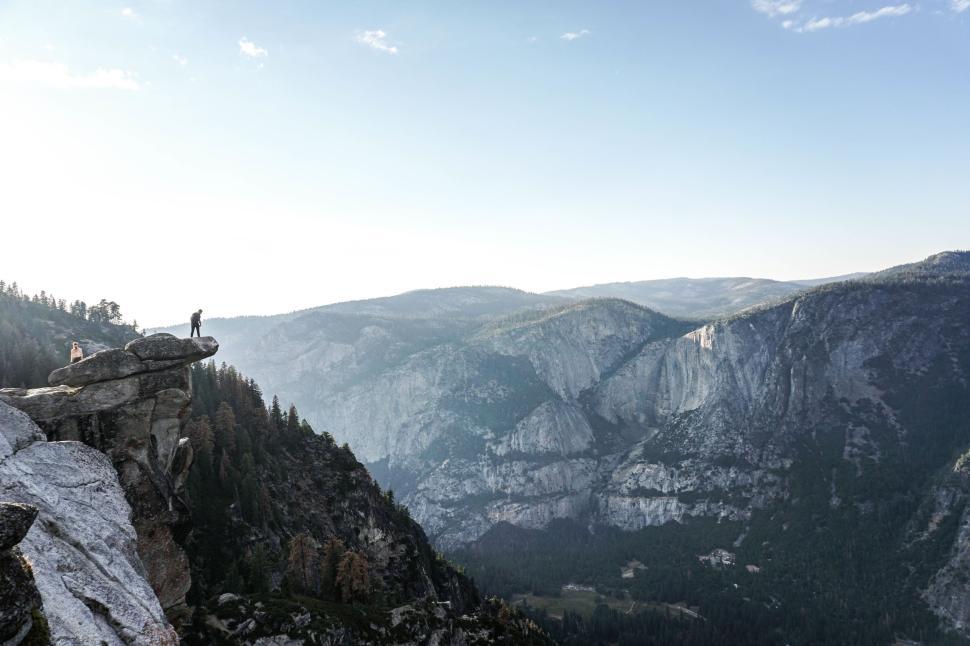 Free Stock Photo of Hiker on mountain cliff overlooking a vast valley ...