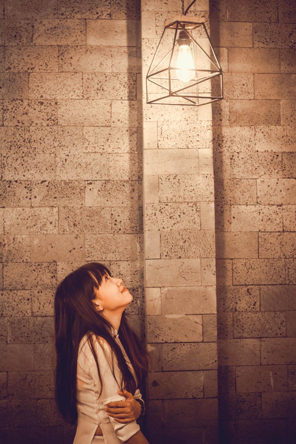 Free Stock Photo of Person looking up at a hanging light on brick wall ...