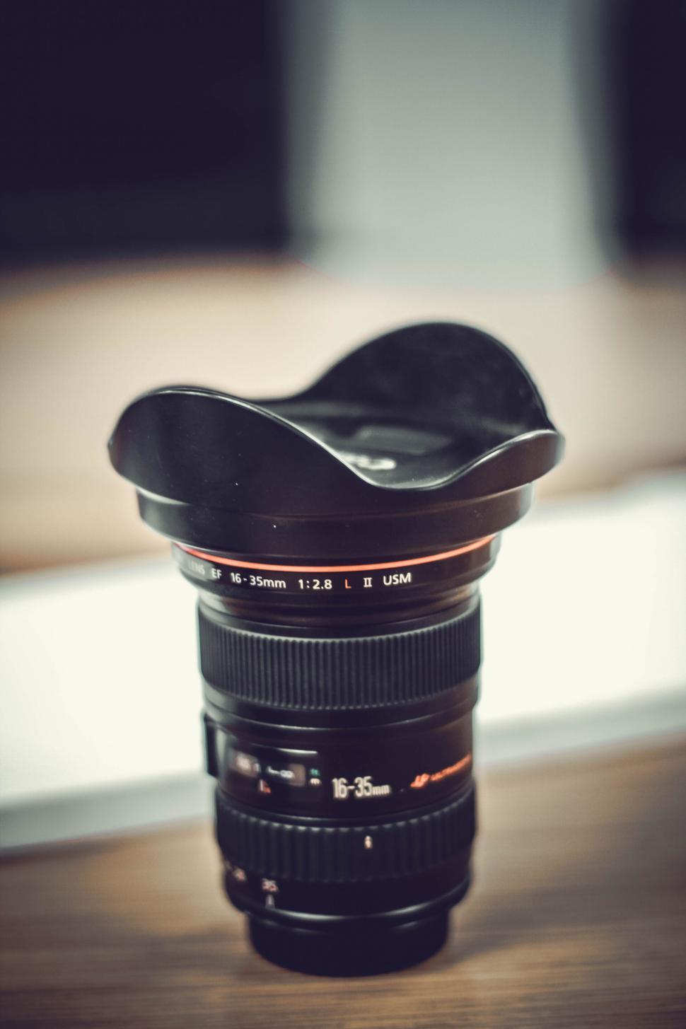 Free Stock Photo of Camera lens standing upright on a wooden surface ...