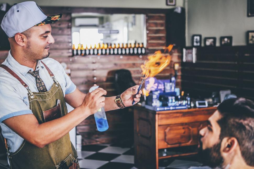Free Stock Photo of Barber holds flaming tools while client waits in ...