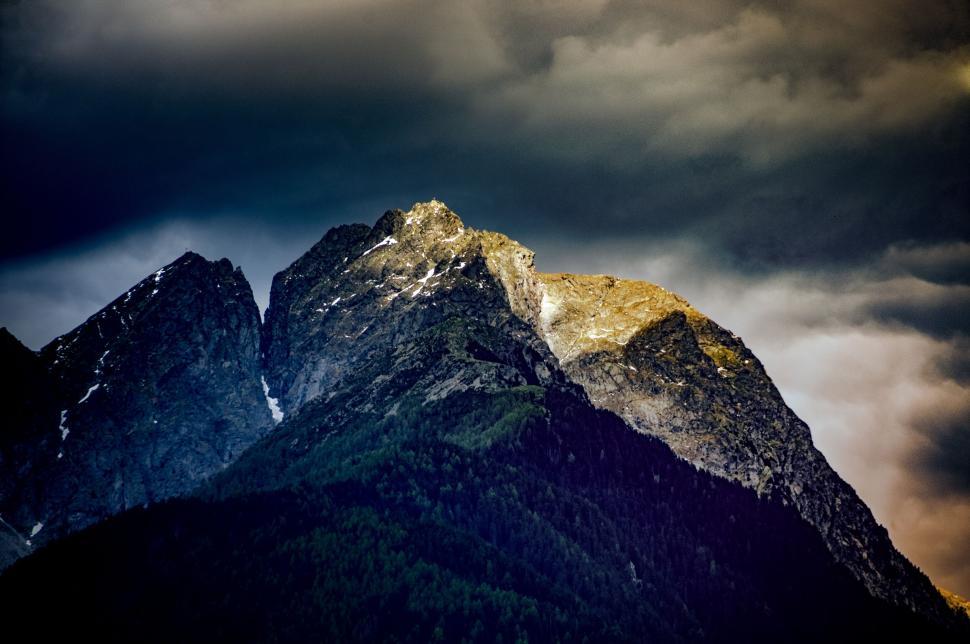 Free Stock Photo of Majestic mountain peaks under a dramatic cloudy sky ...