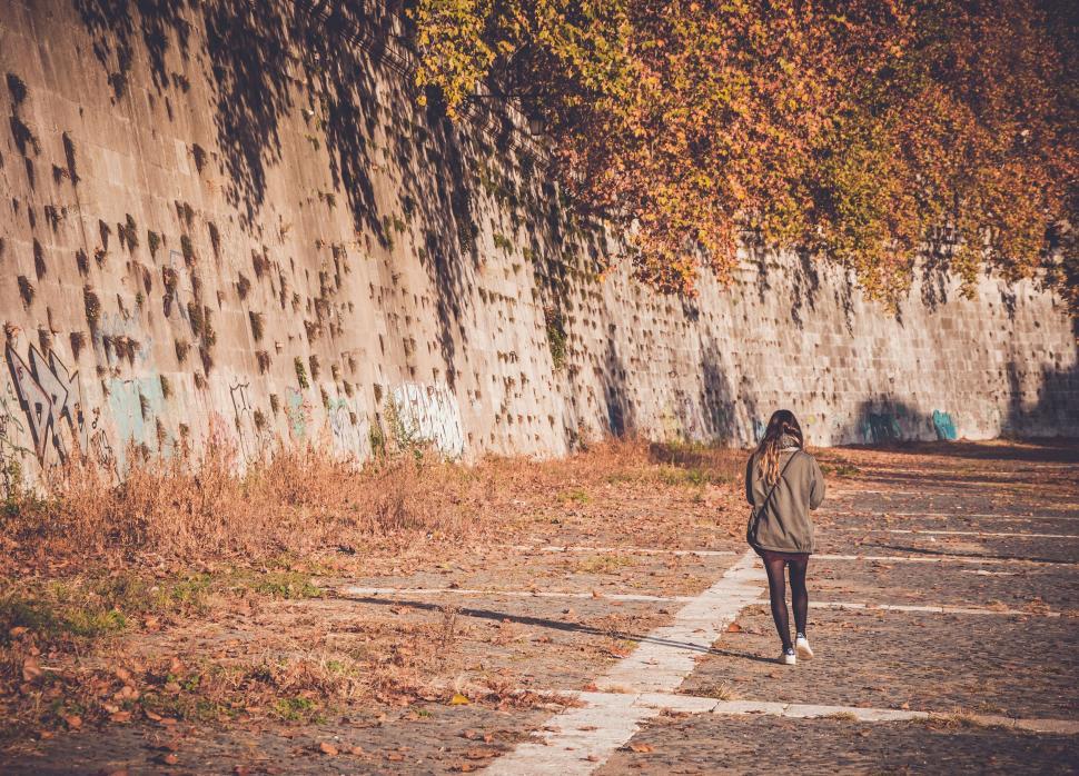 Free Stock Photo of Woman walking alone near wall with graffiti in ...