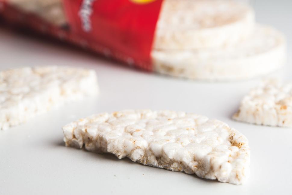 Free Stock Photo of Half-eaten puffed rice cake laying on a white ...