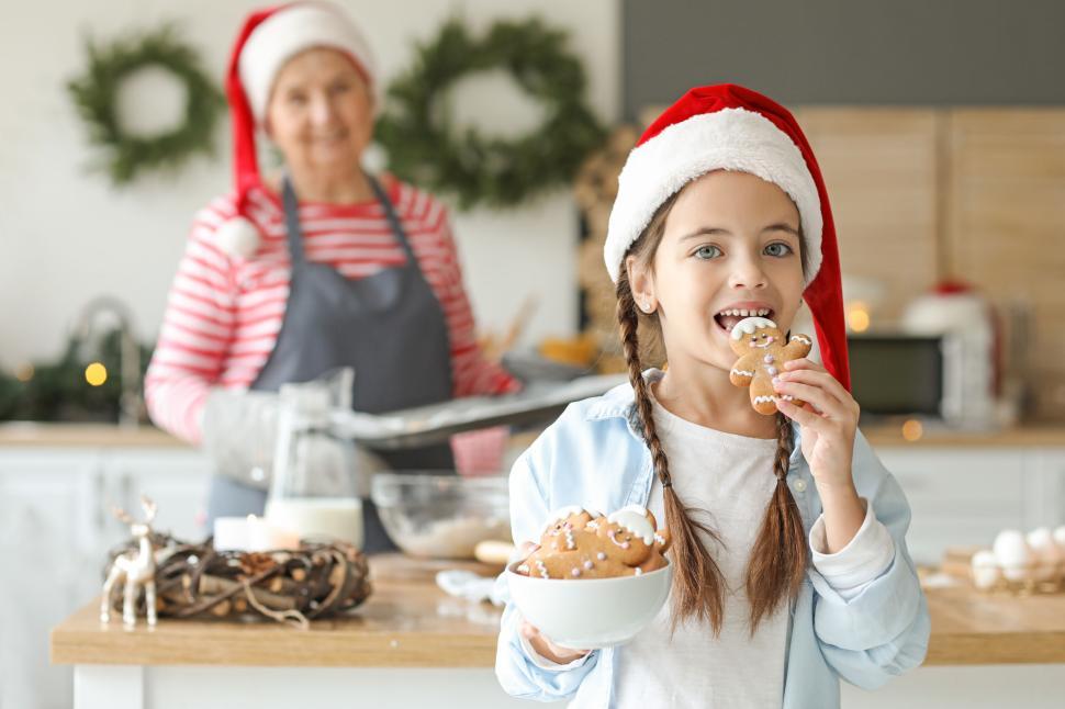 Free Stock Photo of Young girl with Santa hat eating gingerbread cookie ...