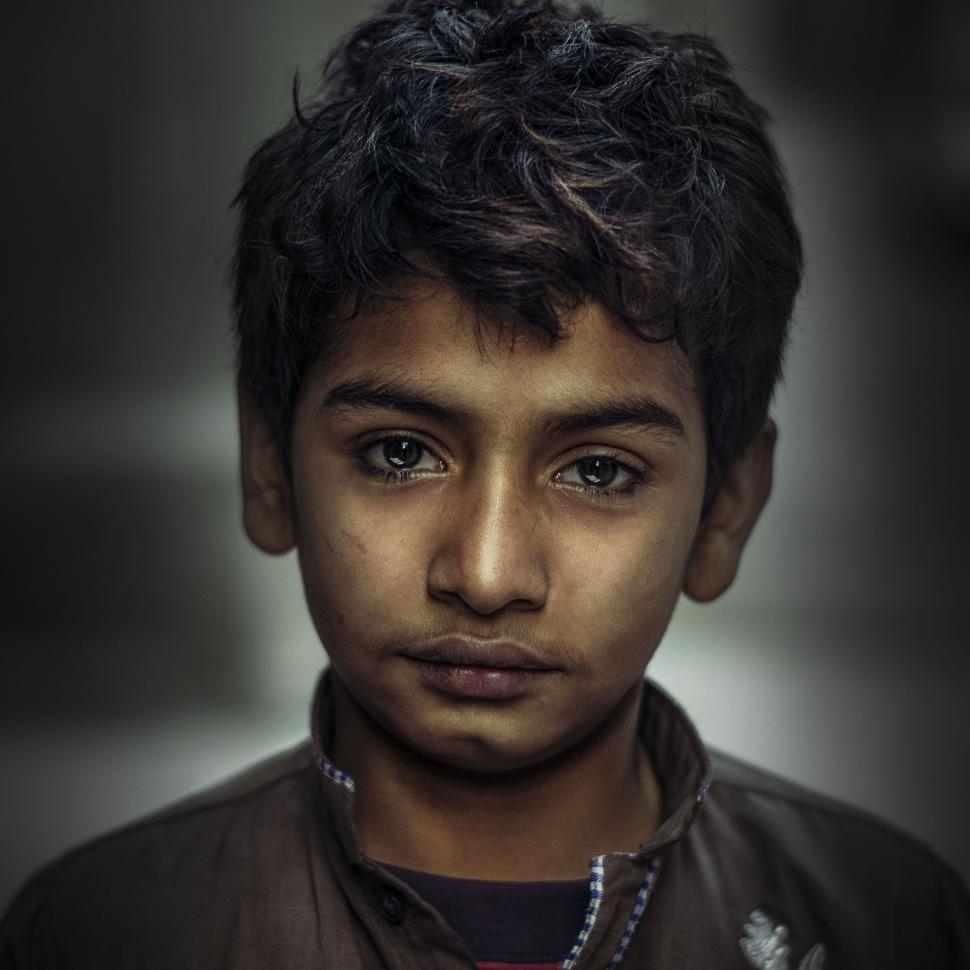 Free Stock Photo of Portrait of a young boy with intense gaze and dark ...