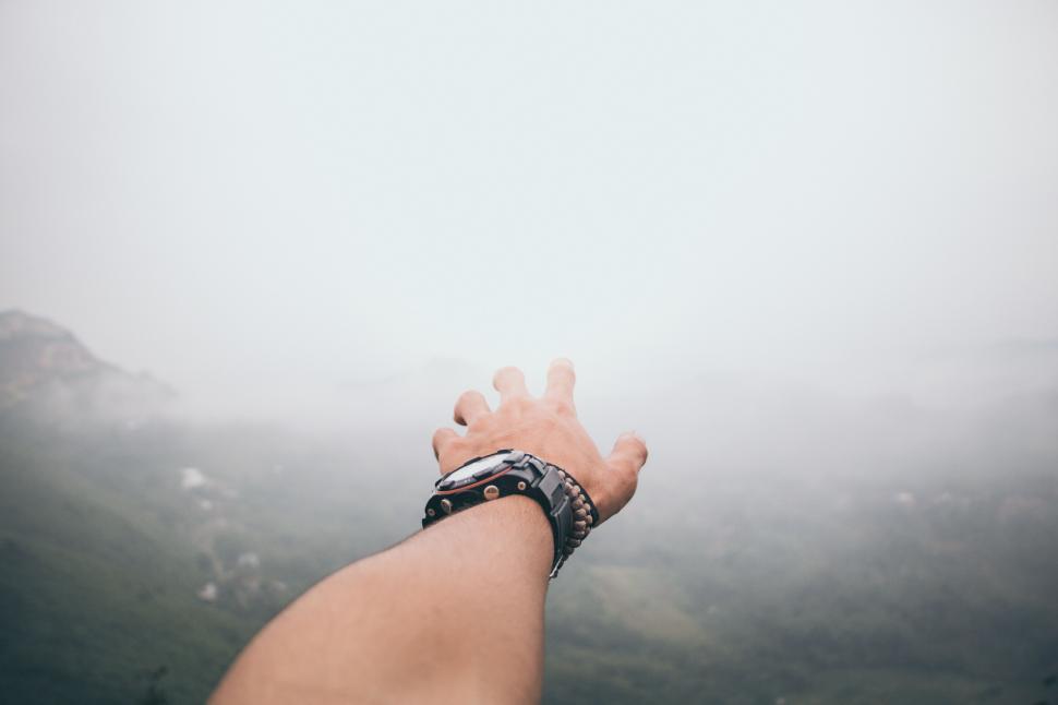 Free Stock Photo of Hand reaching out towards foggy mountains in the ...