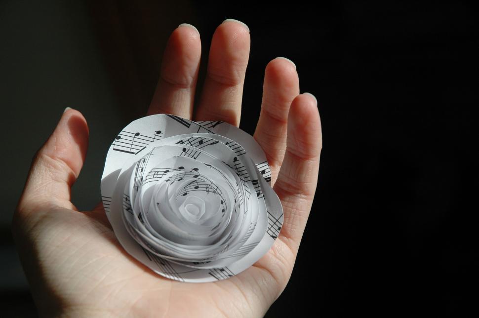 Free Stock Photo of Hand holding rolled sheet music flower crafted ...