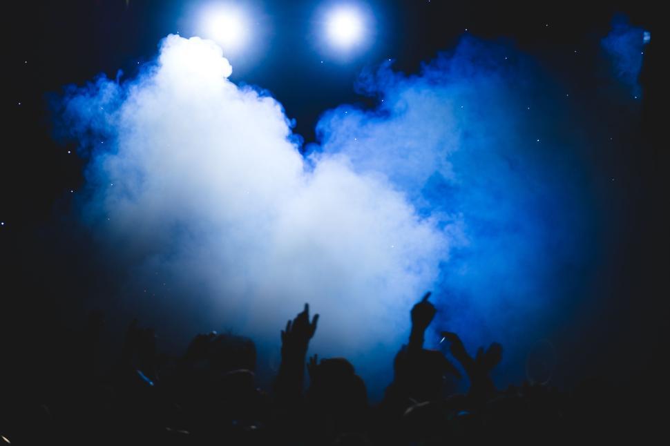 Free Stock Photo of Concert crowd with hands raised under smoky blue ...