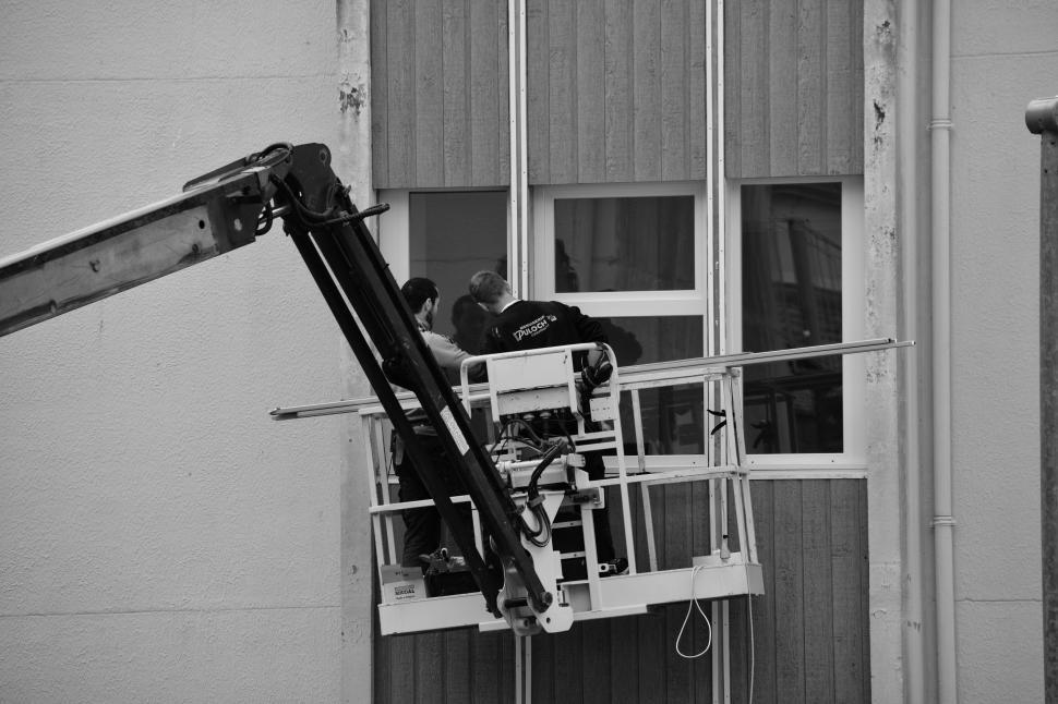 Free Stock Photo of Workers on a high rise platform installing a ...