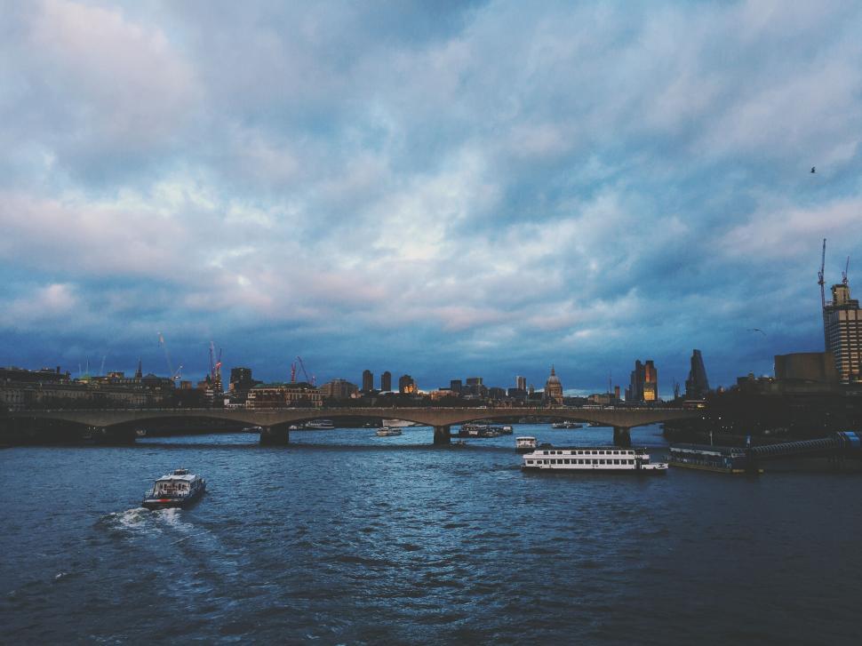 Free Stock Photo of Boats cruising on river under city bridge at sunset ...