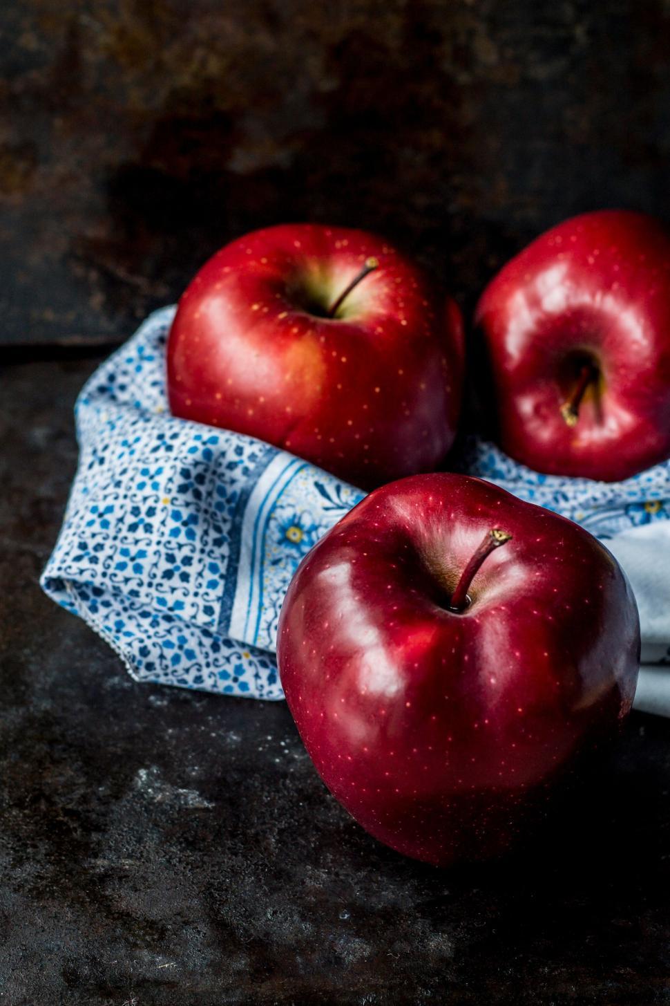 Free Stock Photo of Three red apples on a patterned cloth surface setup ...
