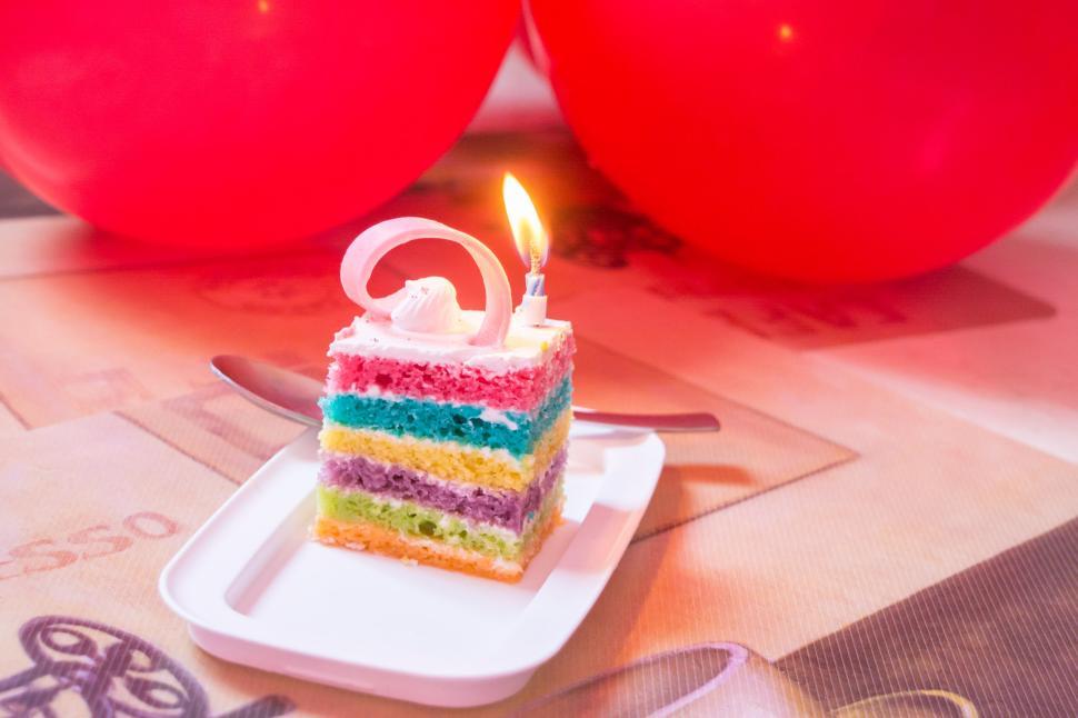 Free Stock Photo of Colorful birthday cake slice with single candle lit ...