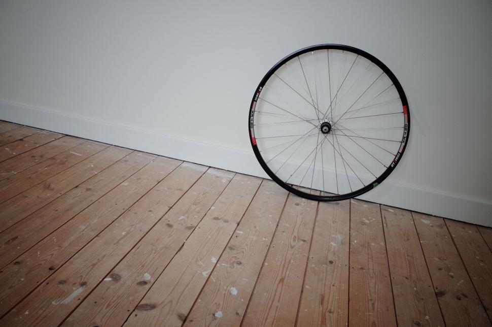 Free Stock Photo of Single bicycle wheel leaning against a plain white ...