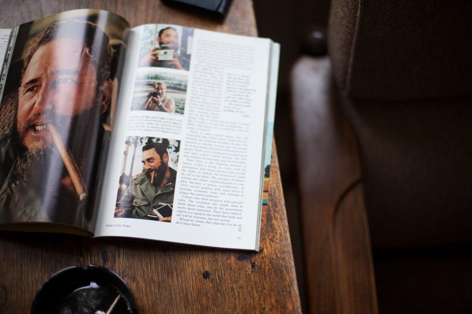 Free Stock Photo of Open magazine on wooden table with blurred images ...