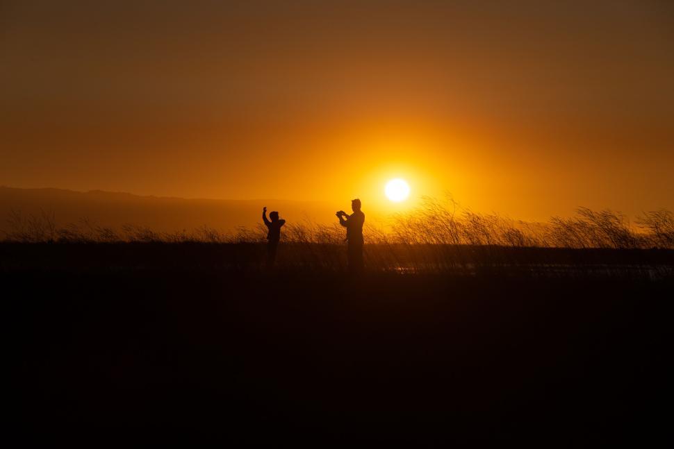 Free Stock Photo of Silhouetted figures pose with camera in sunset ...