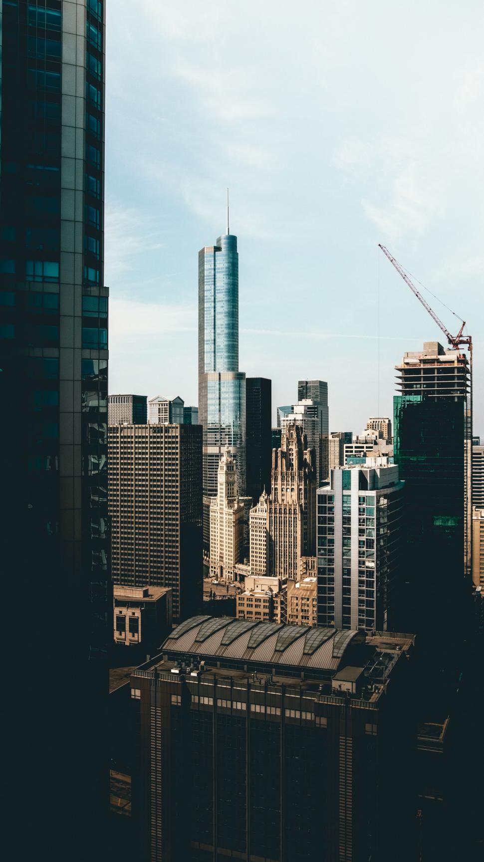 Free Stock Photo of High-rise buildings and a crane against a clear sky ...