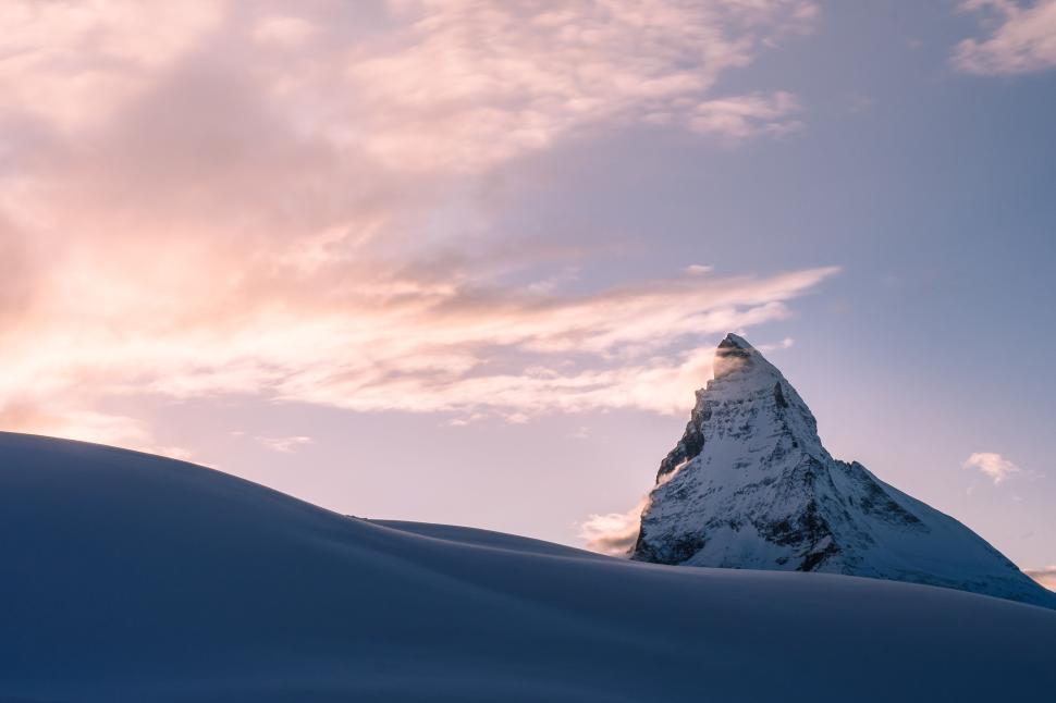 Free Stock Photo of Breathtaking snowy mountain peak under a glowing ...