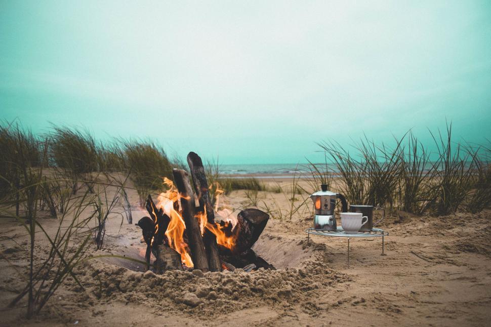 Free Stock Photo of Cozy beach campfire with coffee setup by the sea ...