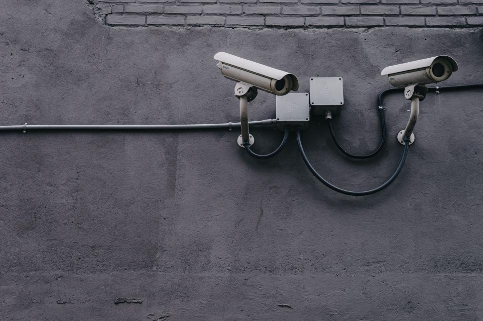 Free Stock Photo of Two surveillance cameras mounted on a gray walls ...