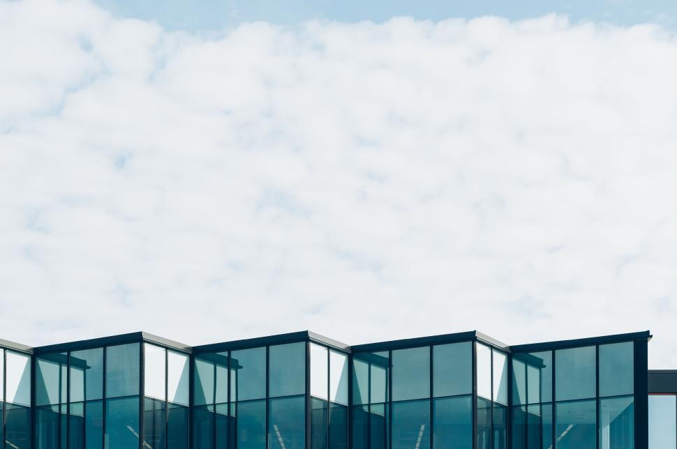 Free Stock Photo of Modern glass facades reflecting cloudy blue sky ...