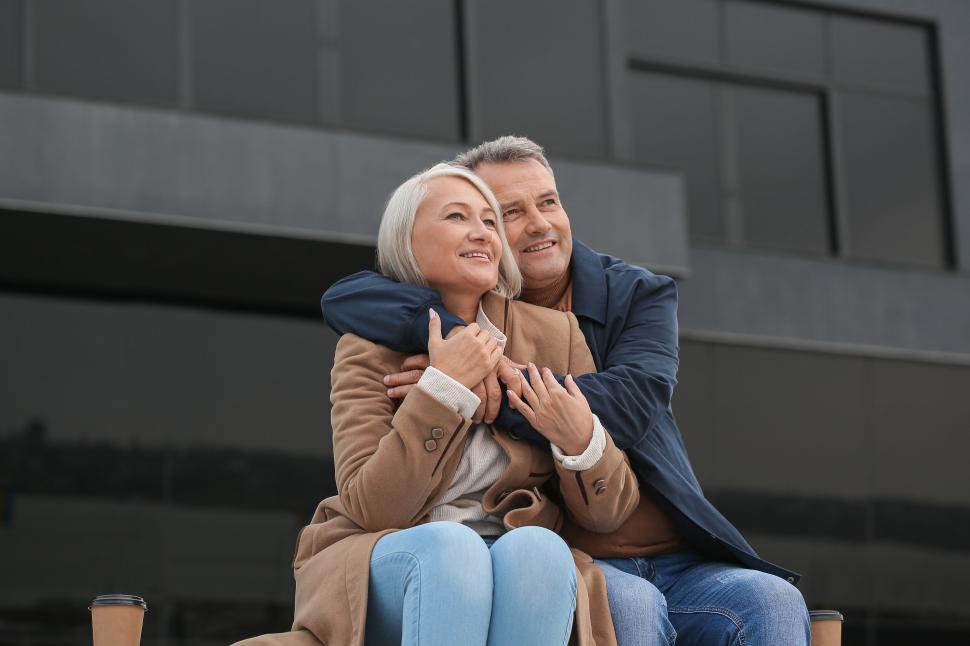 Free Stock Photo of Older couple embracing on a bench outside together ...