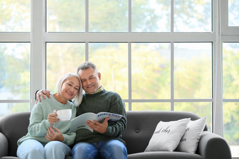 Free Stock Photo of Couple enjoying coffee and reading on a comfy sofa ...