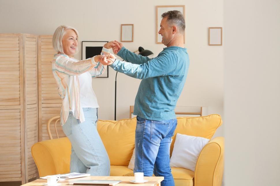 Free Stock Photo of Elderly couple dancing joyfully in the living room ...