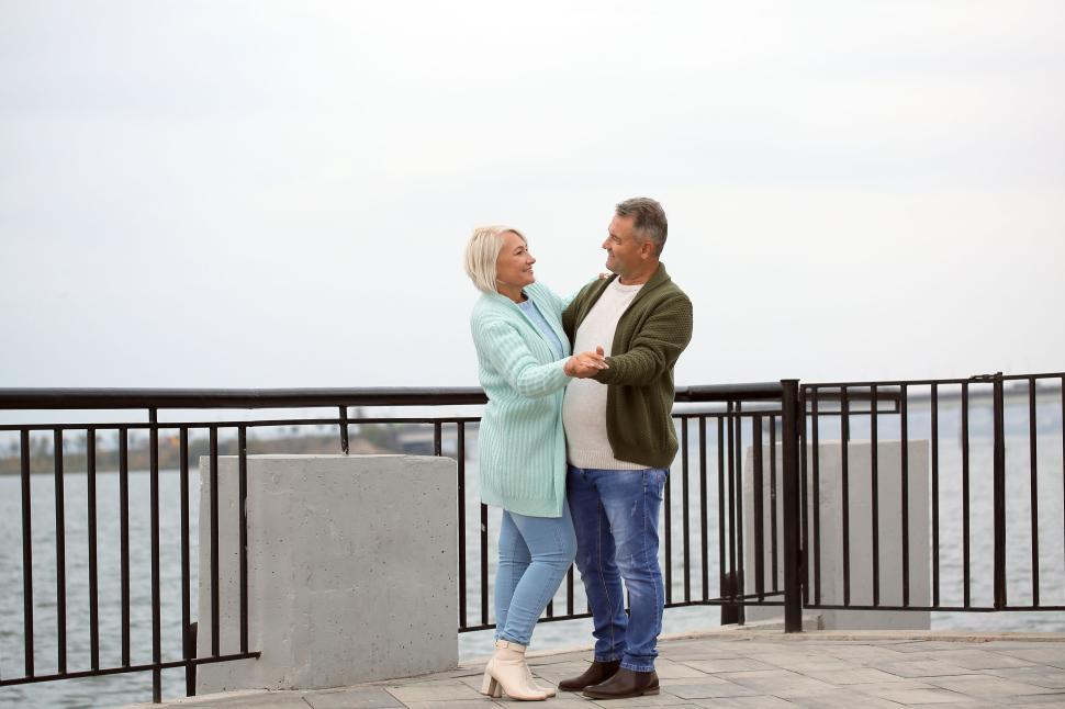 Free Stock Photo of Elderly couple dancing by the waterfront railing ...