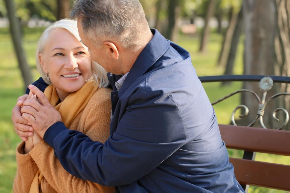 Free Stock Photo of Elderly couple cuddling on a park bench in autumn ...