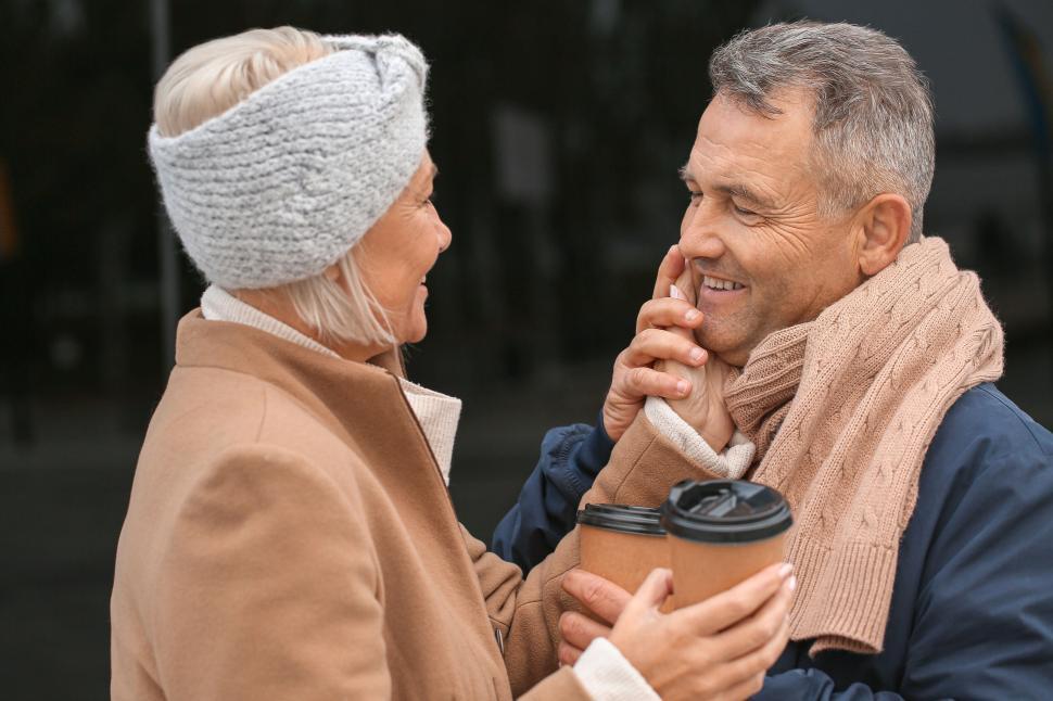 Free Stock Photo of Couple enjoying warm beverages while sharing gaze ...