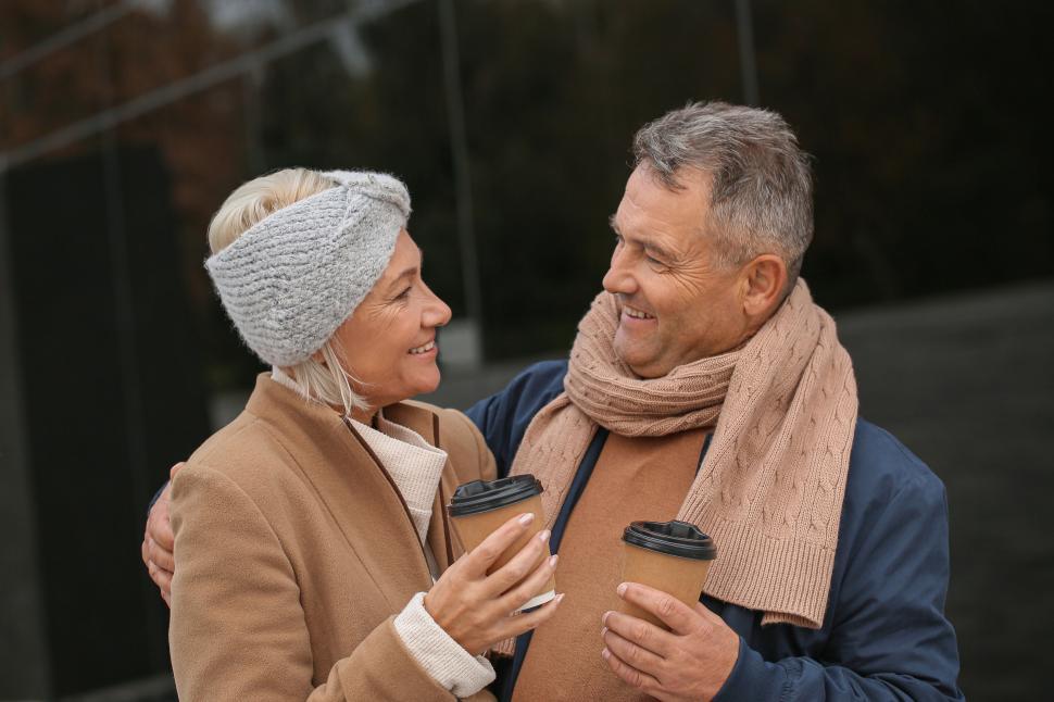 Free Stock Photo of Couple sharing warm drinks with smiles outdoors ...