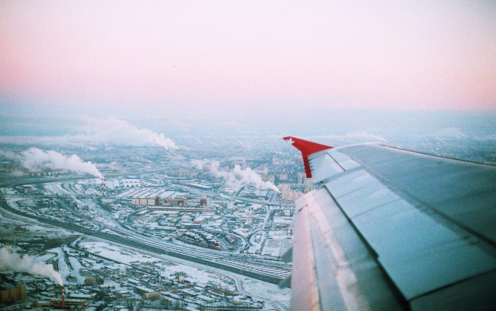 Free Stock Photo of Aerial view of a city covered in snow with airplane ...