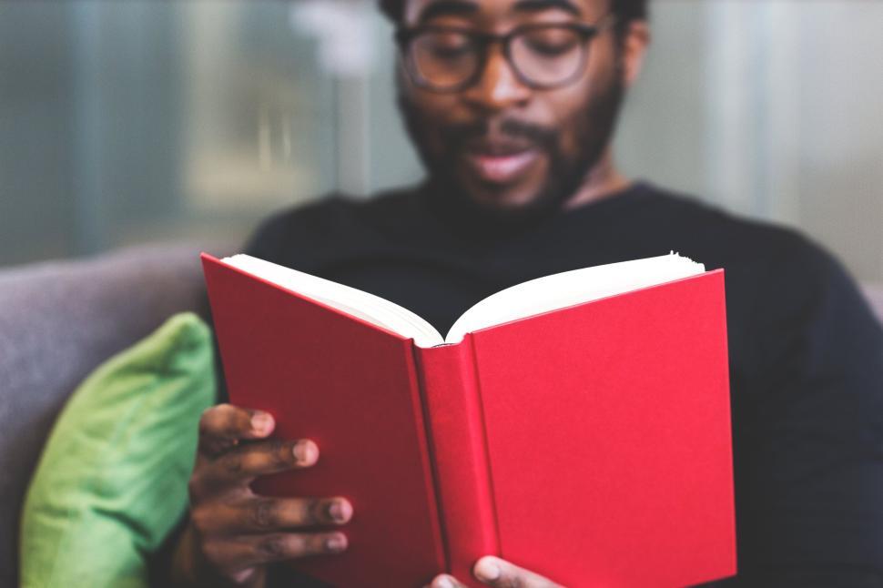 Free Stock Photo of Man reading a red book indoors with a relaxed ...