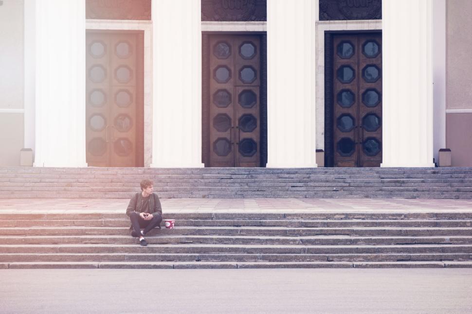 Free Stock Photo of Person resting on steps of grand building with ...