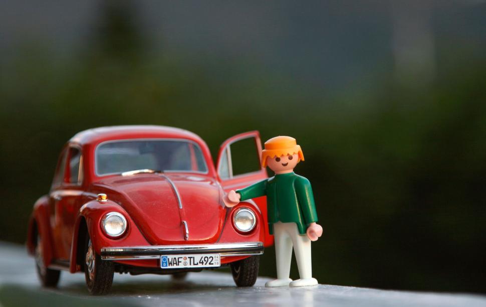 Free Stock Photo of Toy figure standing beside a vintage red toy car ...