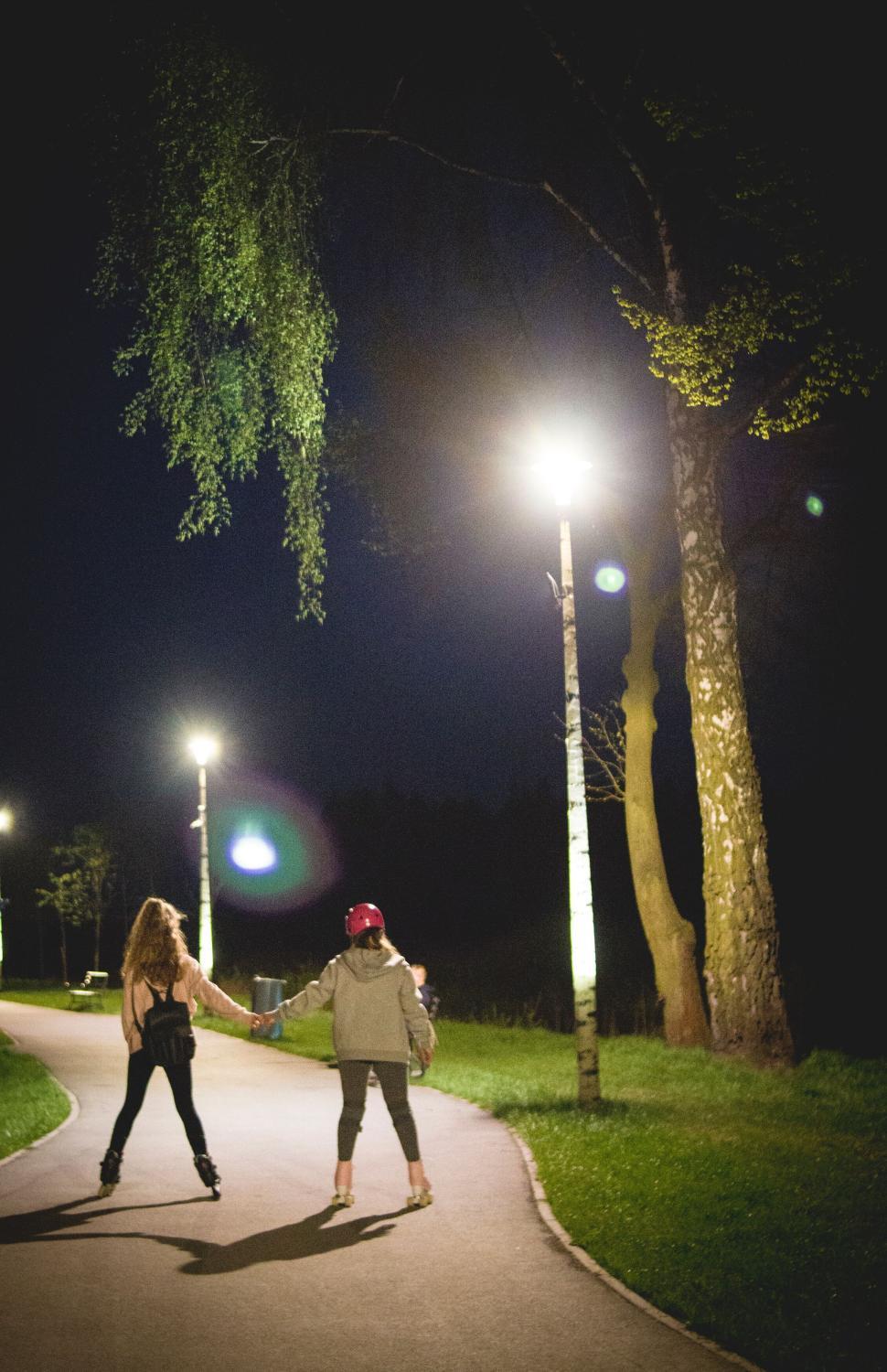 Free Stock Photo of Two people holding hands walking on street at night ...