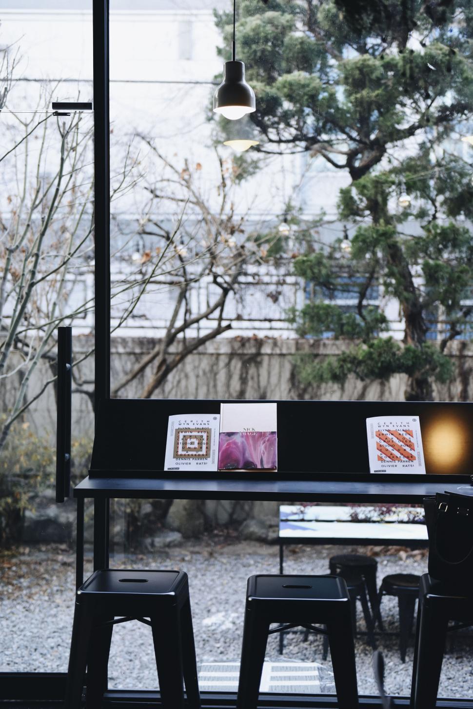 Free Stock Photo of Empty caf? table with books and stool near large ...