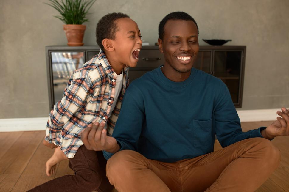 Free Stock Photo of African American laughing dad trying to meditate ...