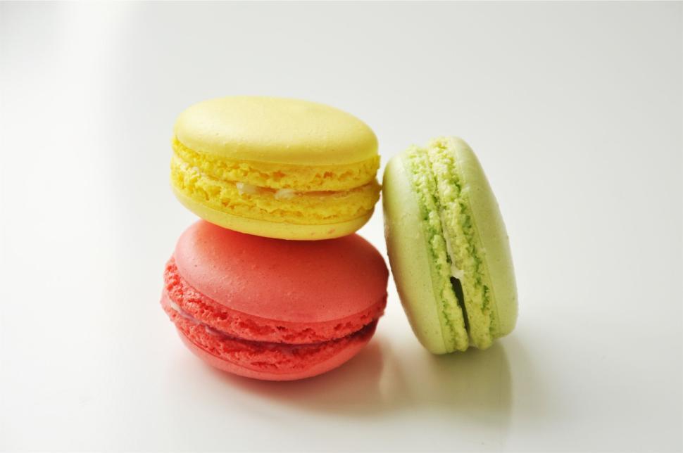 Free Stock Photo of Three brightly colored macarons on a white surface ...